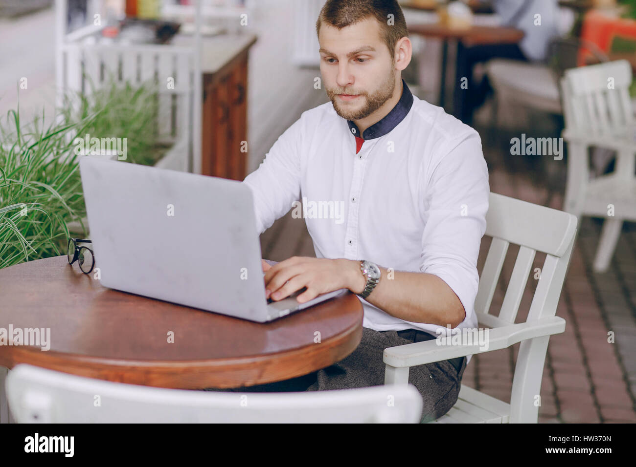 man with laptop in cafe Stock Photo - Alamy