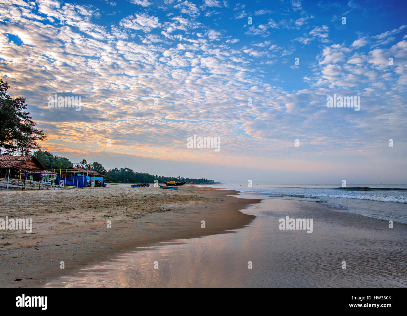 India, Goa. Early morning on the beach Colva. Rising sun illuminates ...