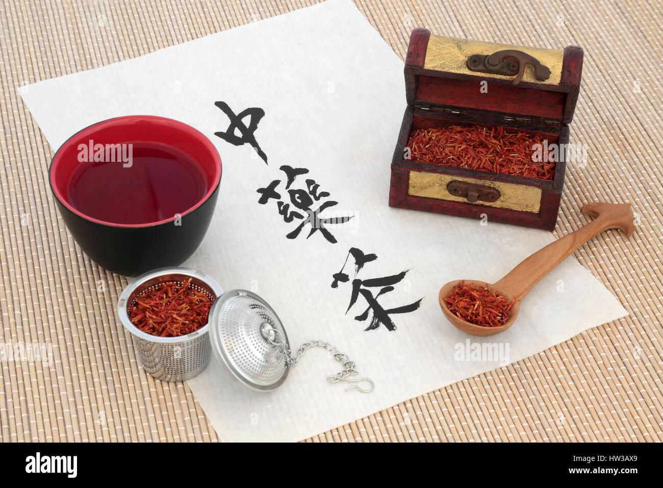 Chinese safflower herb tea with calligraphy on rice paper, tea cup, old ...