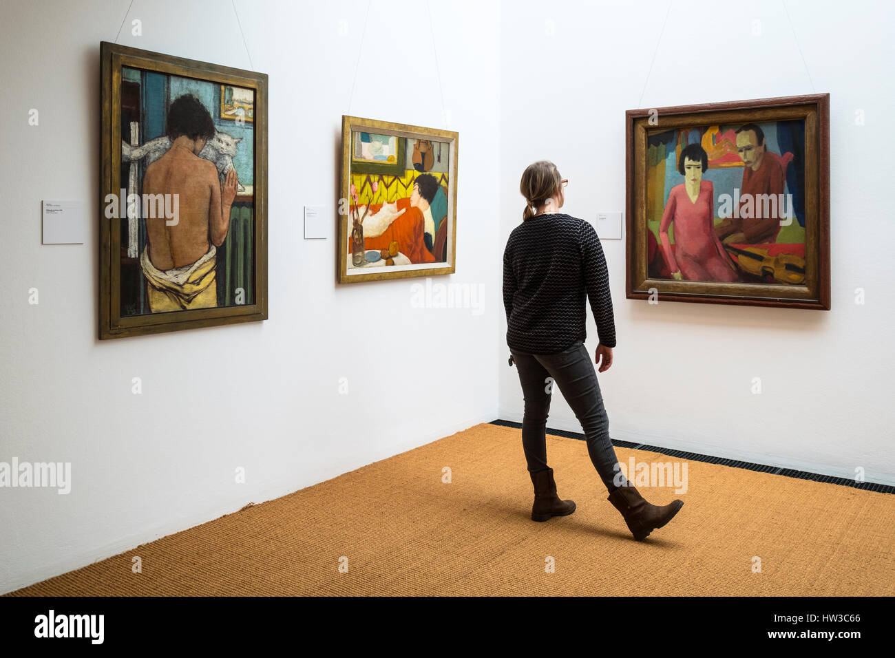Visitors looking at paintings by Max Kaus at Brucke Museum in Dahlem ...