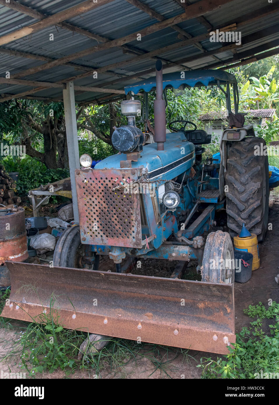 Dirty old tractor parked under a shed on the farm Stock Photo - Alamy