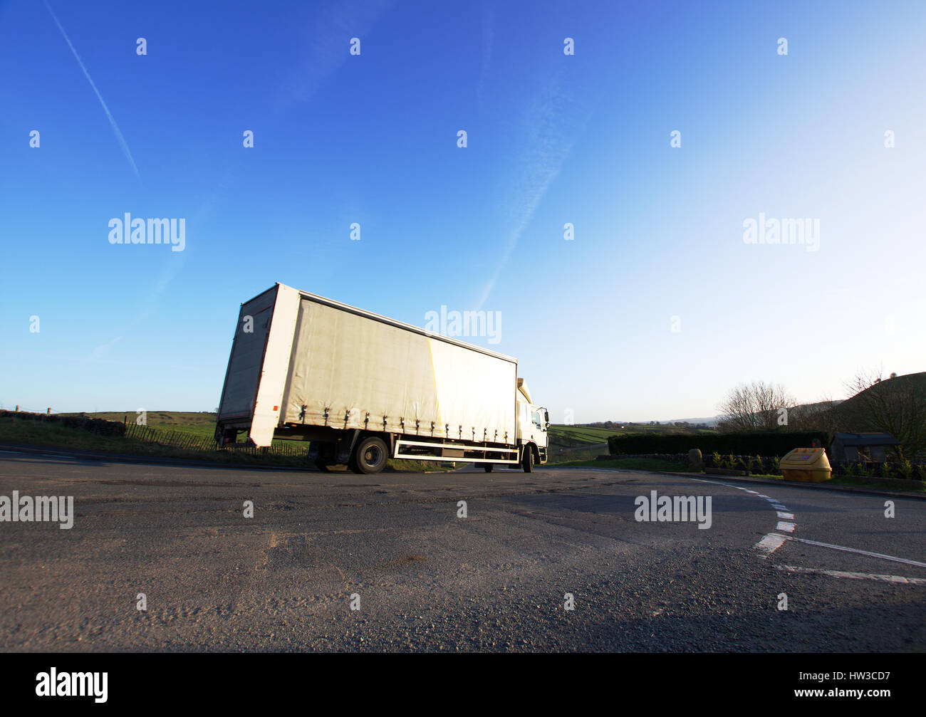 Lorry driving on road bend,blue sky,rural,countryside road in Peak ...