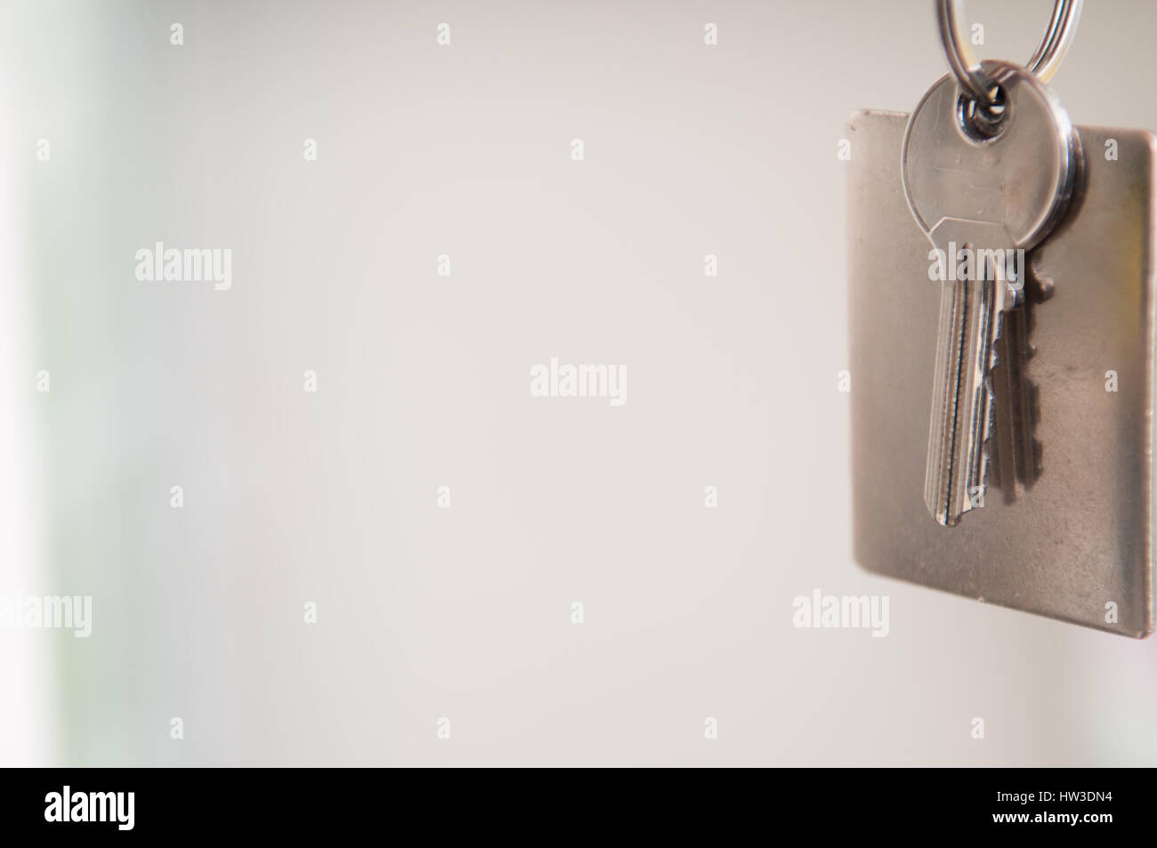 Set of door keys on a blurred background Stock Photo - Alamy