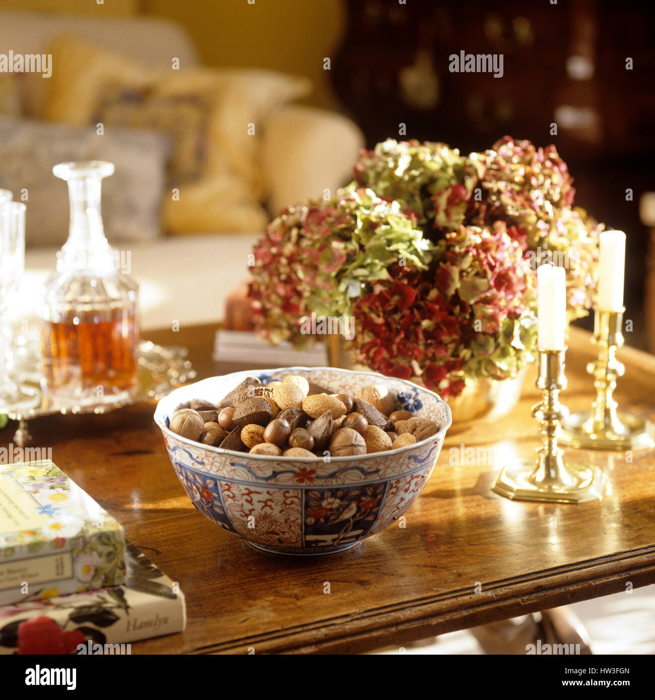 Bowl of nuts on coffee table Stock Photo - Alamy