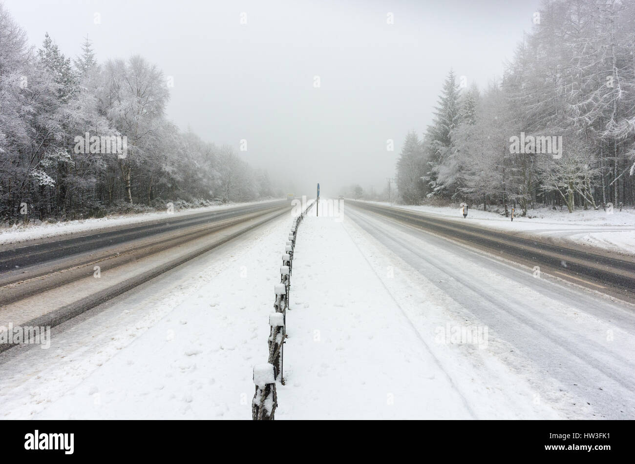 Heavy snow covers the road and results in hazardous driving conditions ...