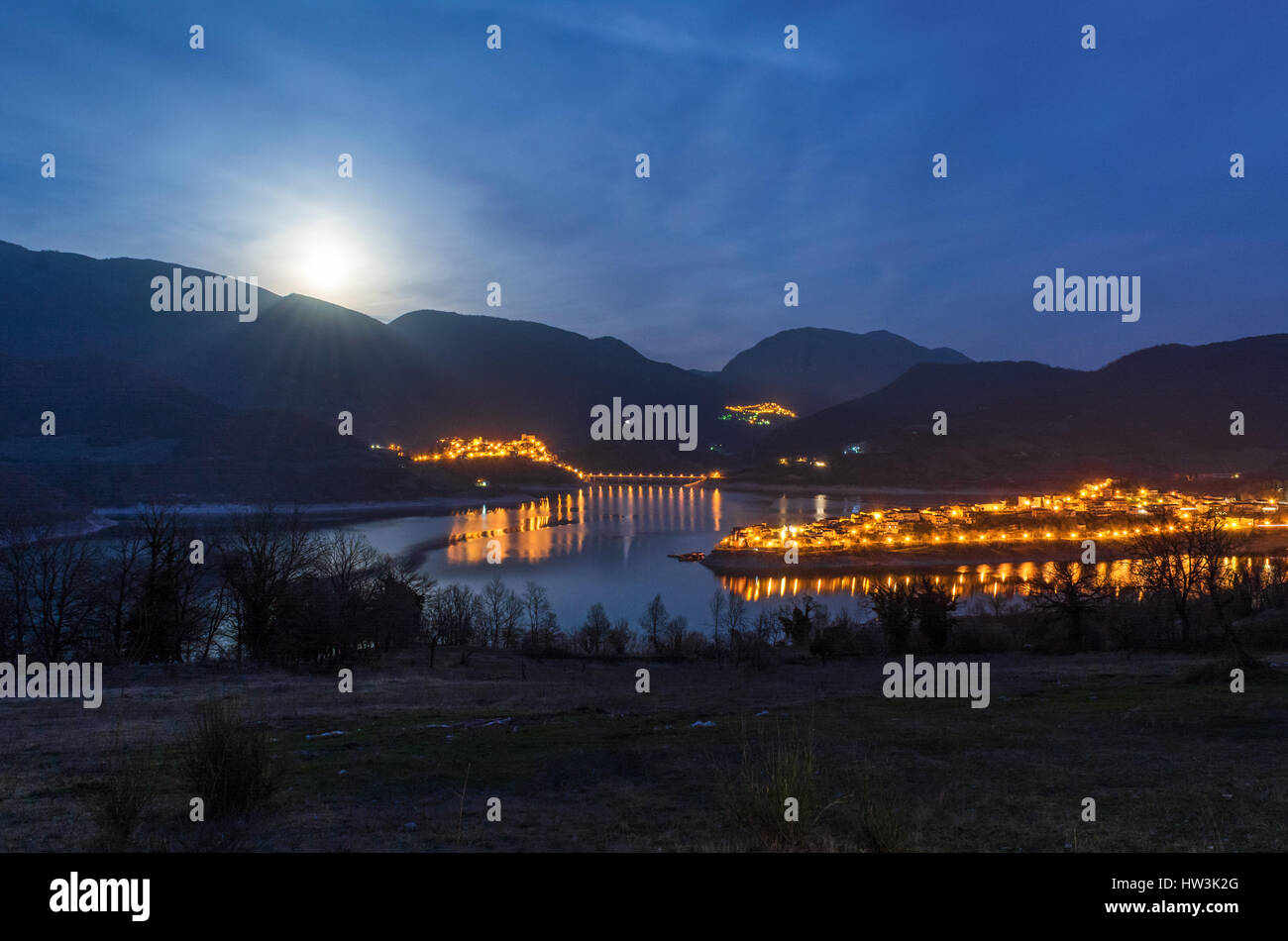 Turano lake in the night (Rieti, Italy) with the Moon and the town of ...