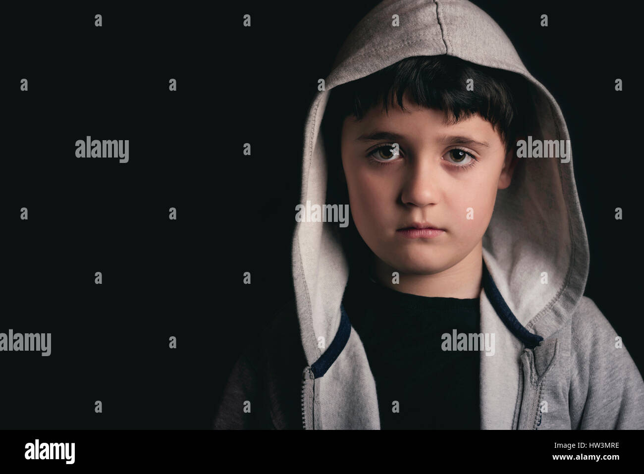 Sad boy on black background Stock Photo - Alamy