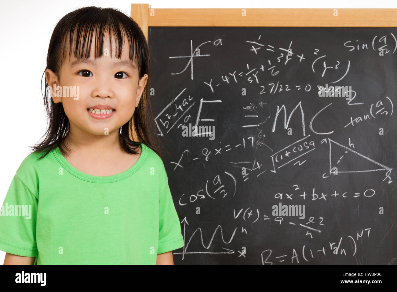 Asian Chinese children againts blackboard or chalkboard with formulas ...