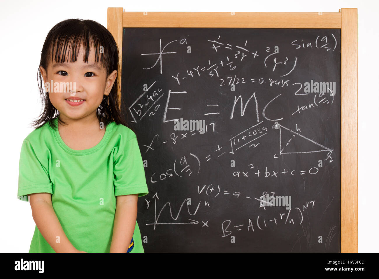 Asian Chinese children againts blackboard or chalkboard with formulas ...