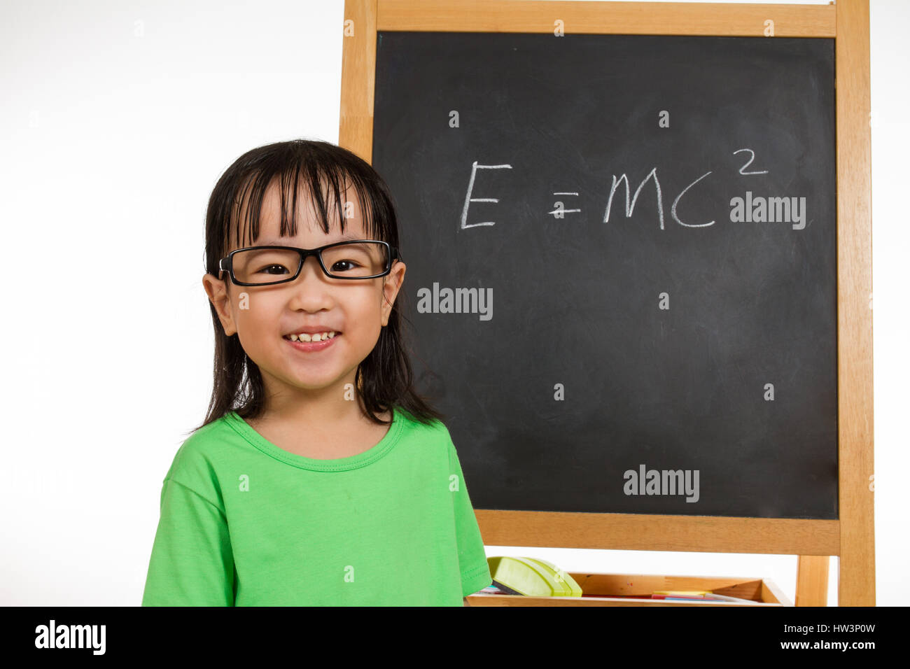 Asian Chinese children againts blackboard or chalkboard with formulas ...