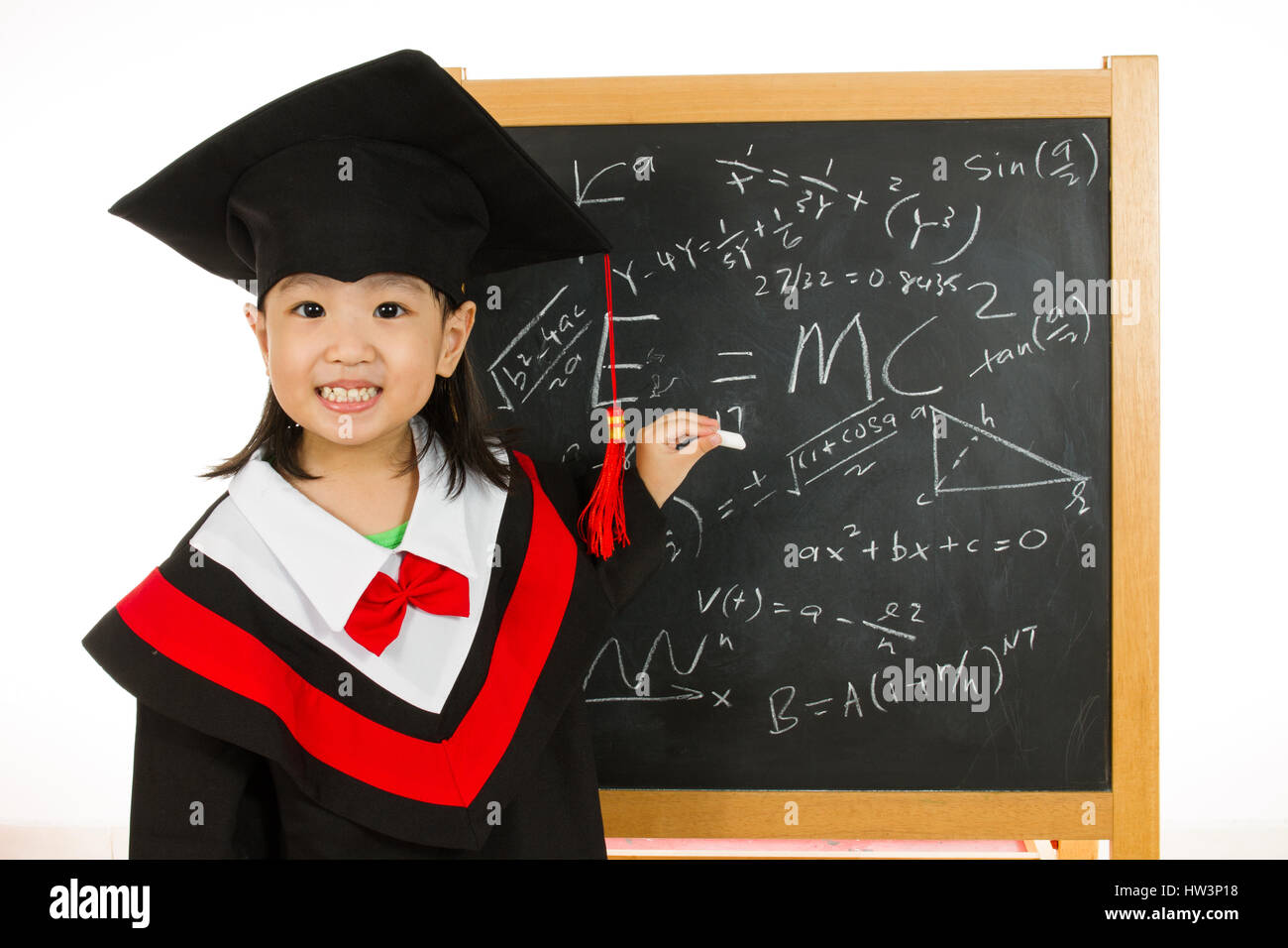 Asian Chinese children in graduation gown againts blackboard or ...