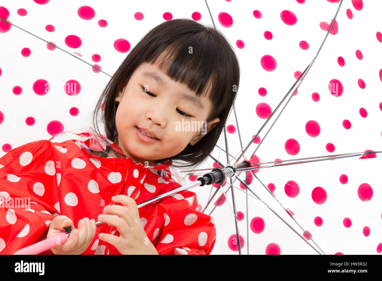 Chinese Little Girl Holding umbrella with raincoat in plain white ...