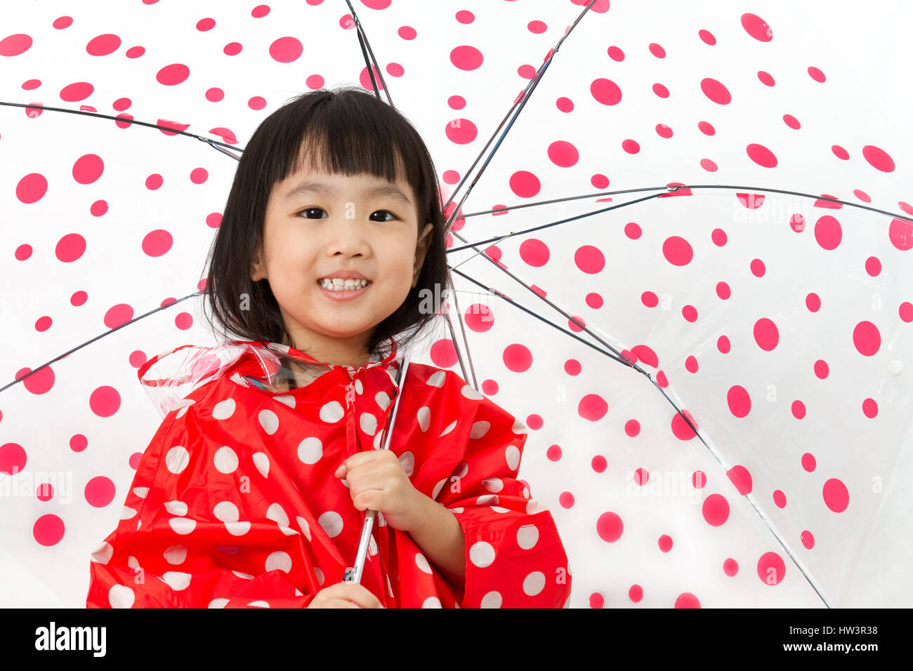 Chinese Little Girl Holding umbrella with raincoat in plain white ...