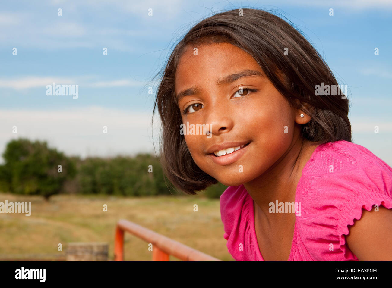Hispanic little girl playing outside Stock Photo - Alamy