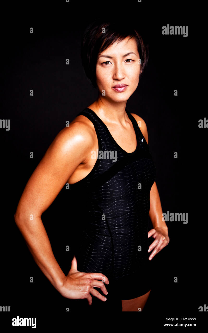 Fit Asian woman isolated on black Stock Photo - Alamy
