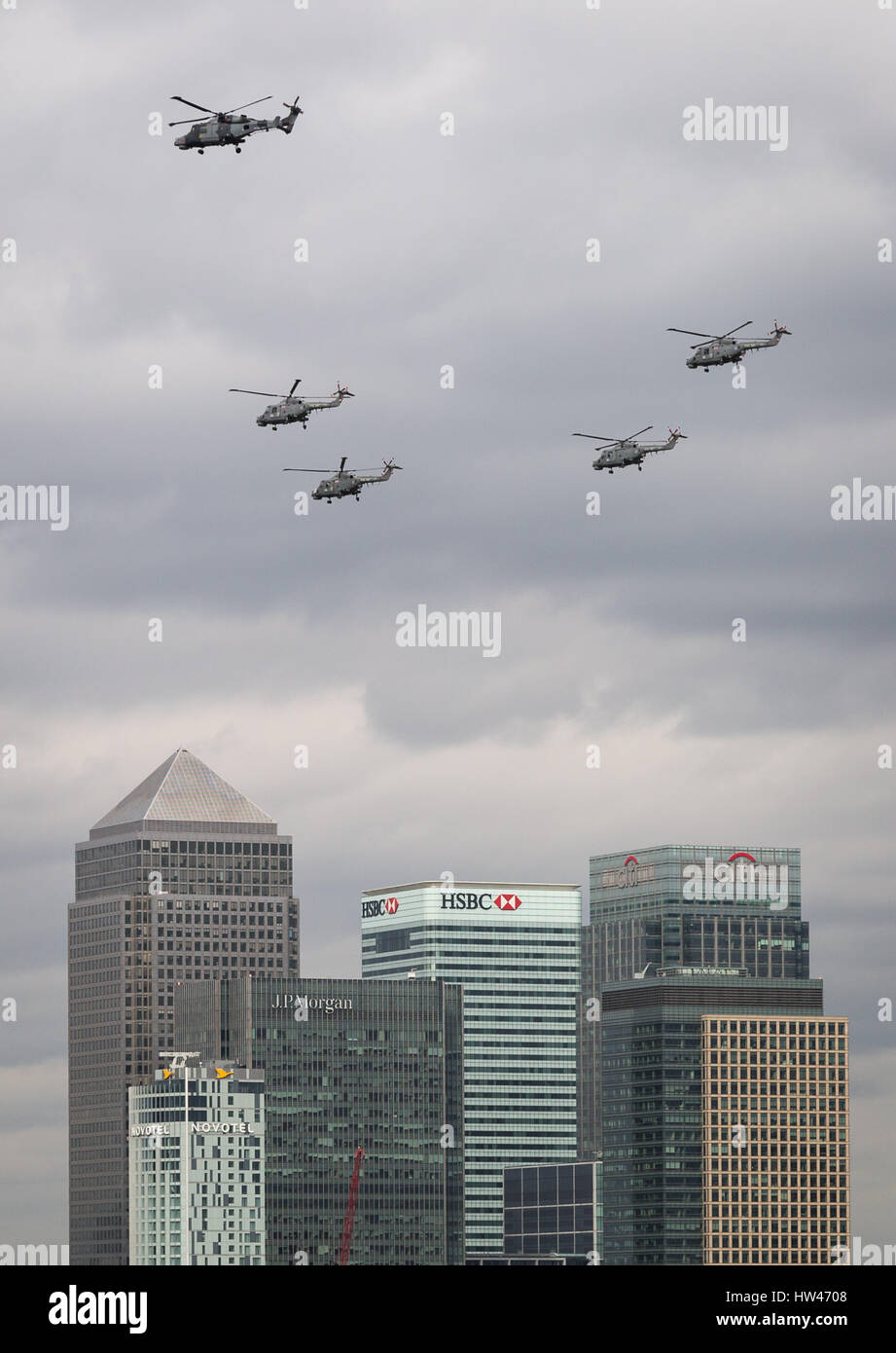 London, UK. 17th March, 2017. Mk8 Lynx helicopters fly over Canary Wharf business park buildings ...