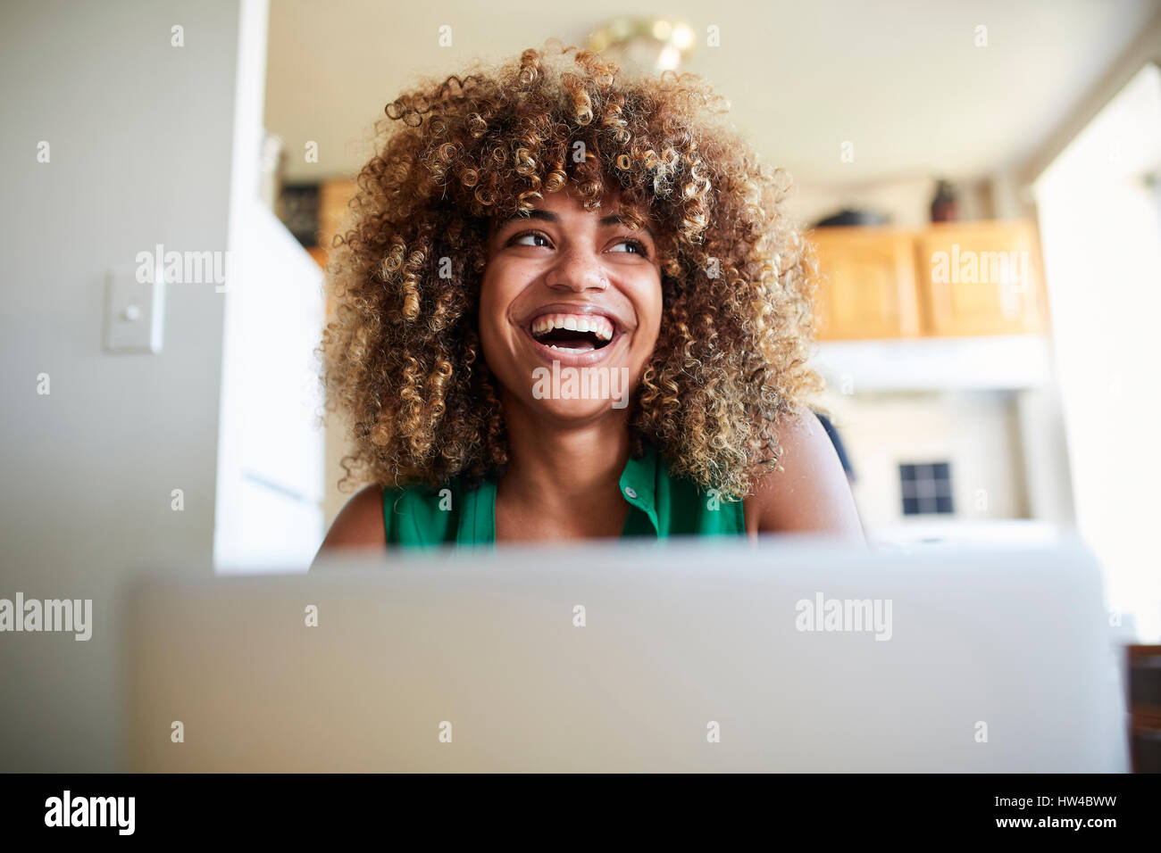 Woman afro hair using laptop hi-res stock photography and images - Alamy