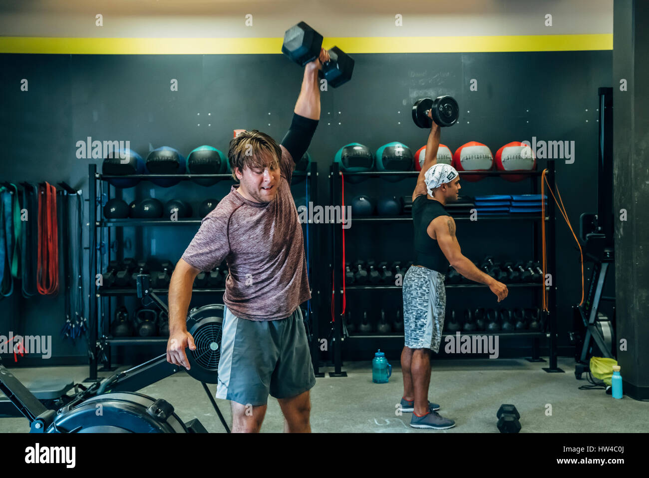 Men lifting weights in gymnasium Stock Photo - Alamy
