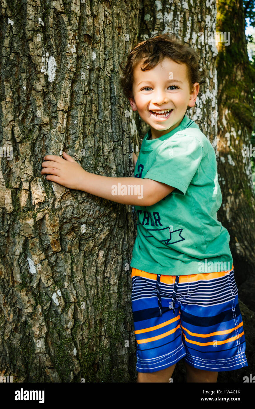 Boy hugging tree hi-res stock photography and images - Alamy