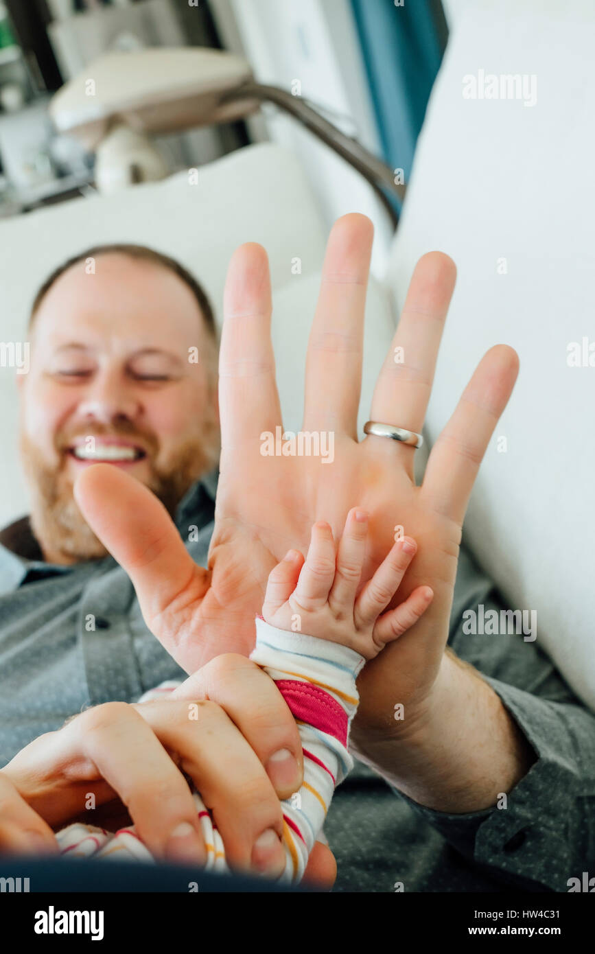 Father high-fiving baby daughter Stock Photo - Alamy