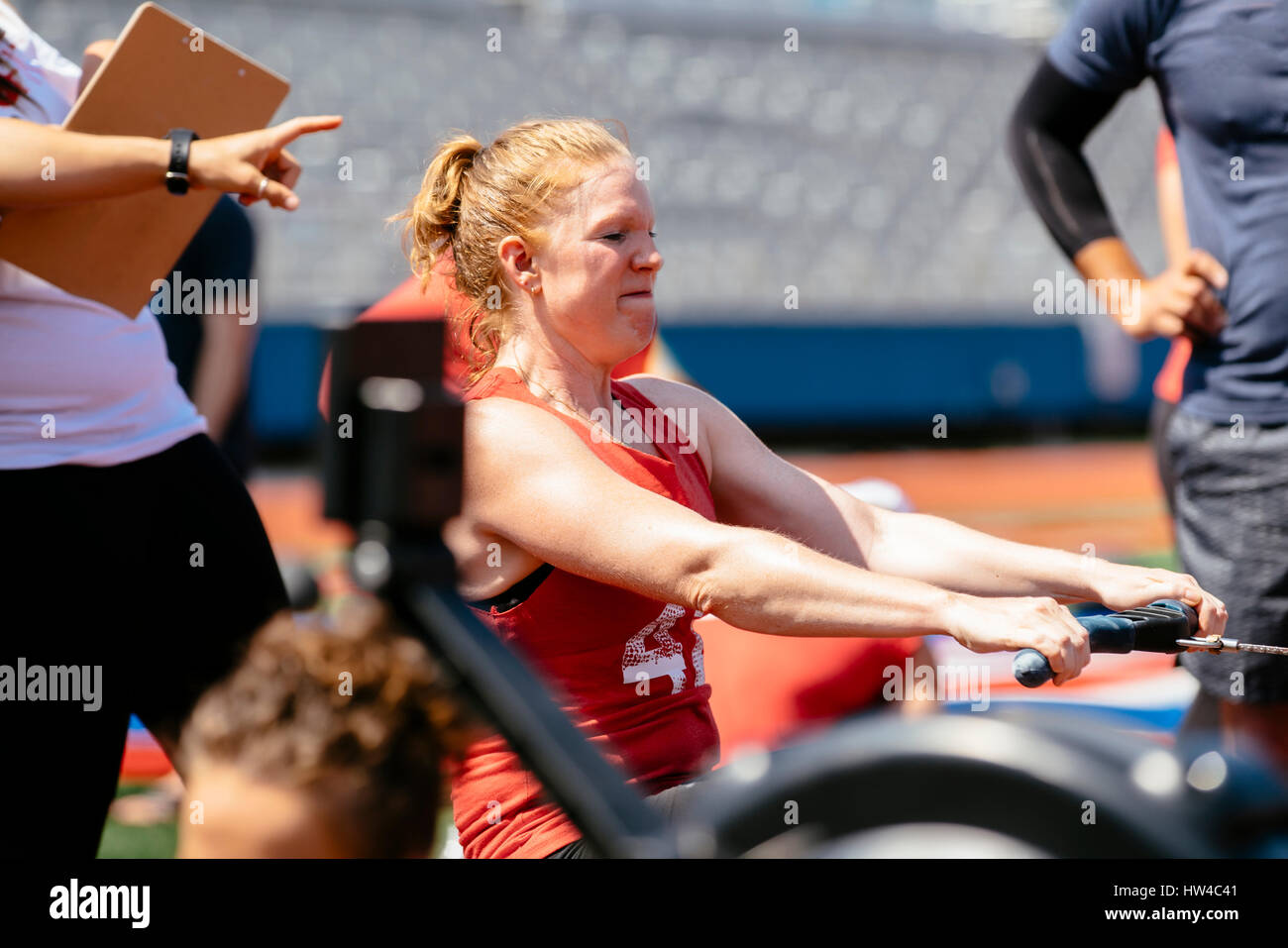 Woman using rowing machine outdoors Stock Photo - Alamy