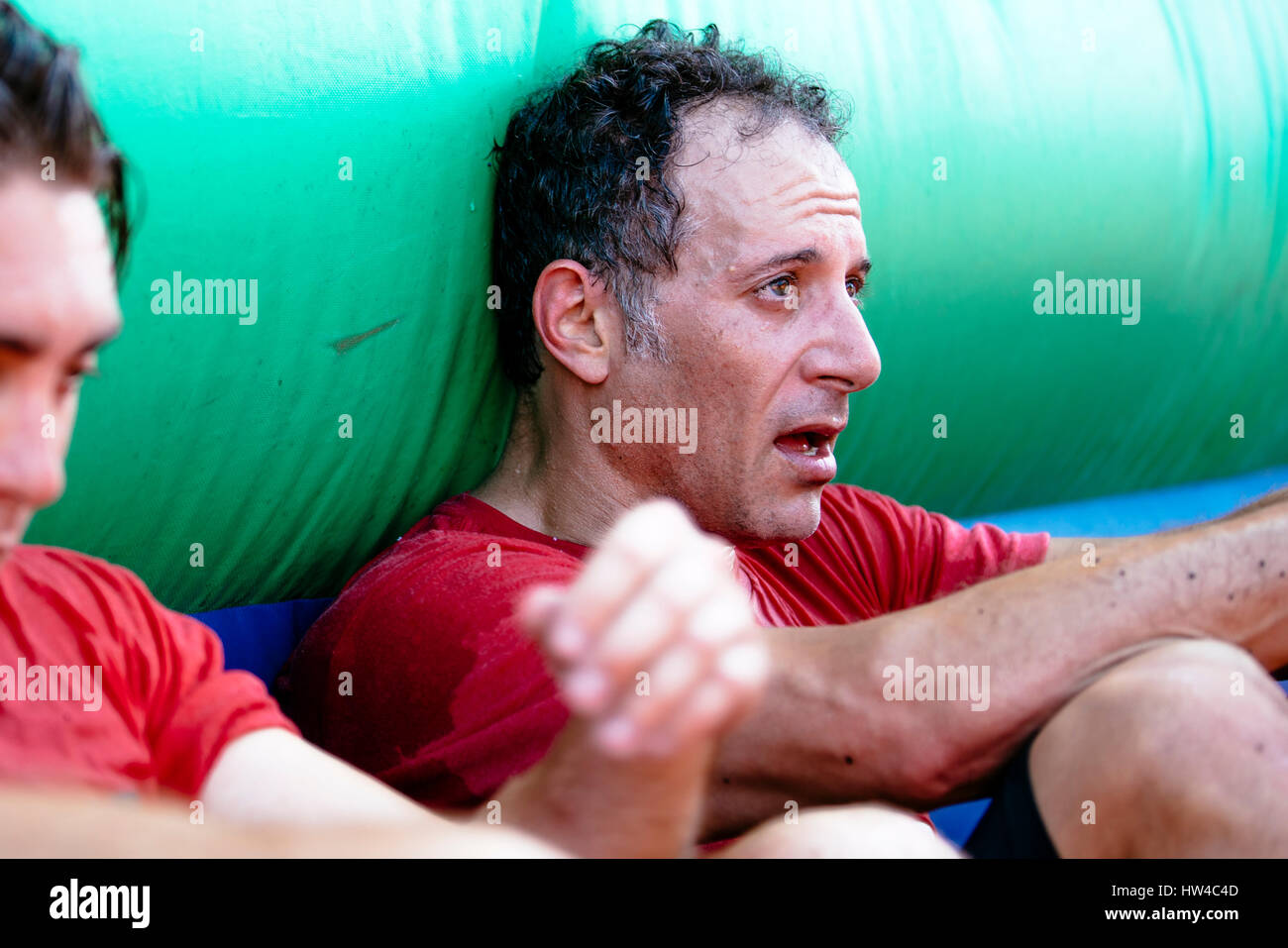 Fatigued Caucasian men resting outdoors Stock Photo - Alamy