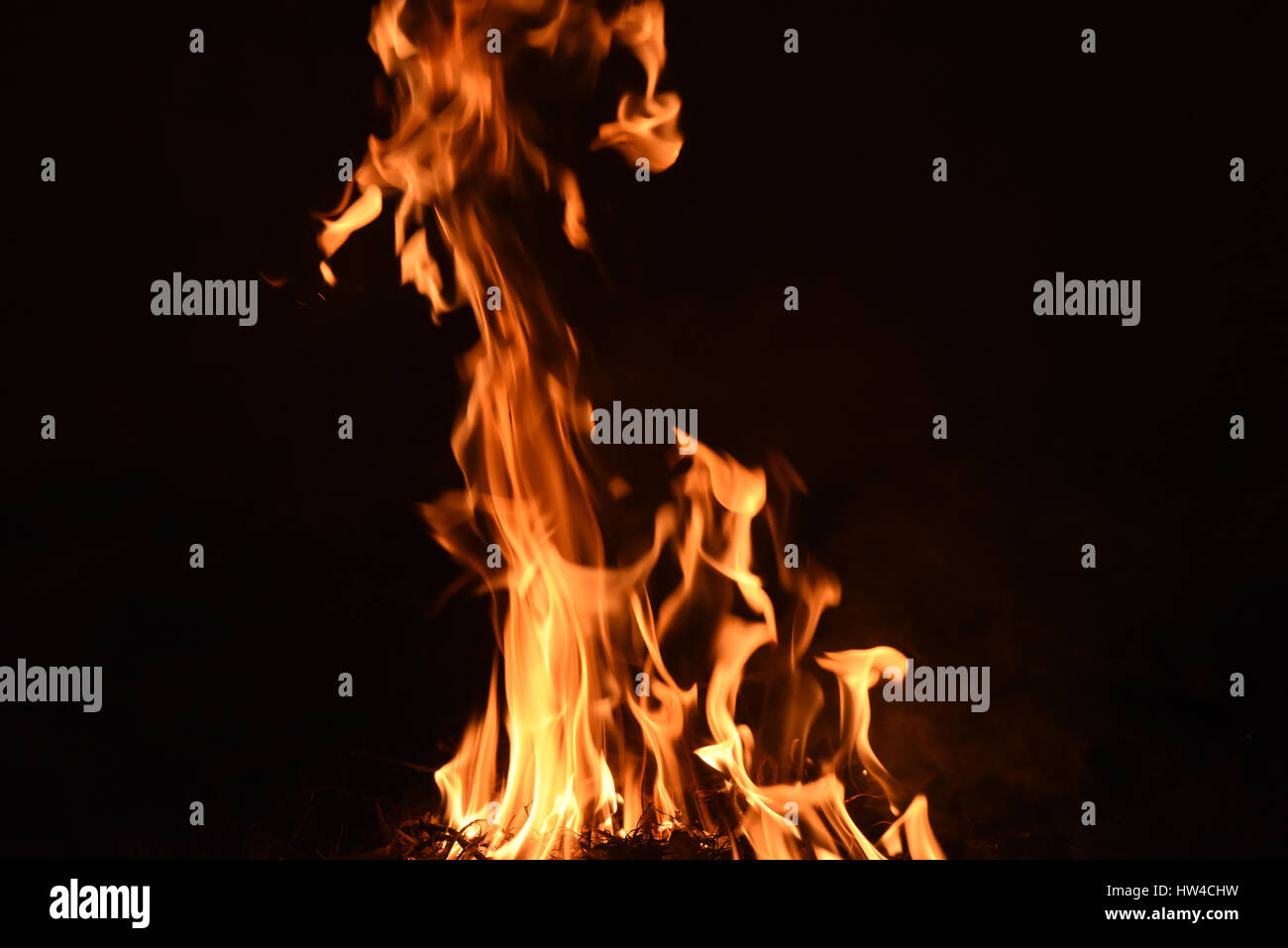 Burning fire background detail on black background Stock Photo - Alamy