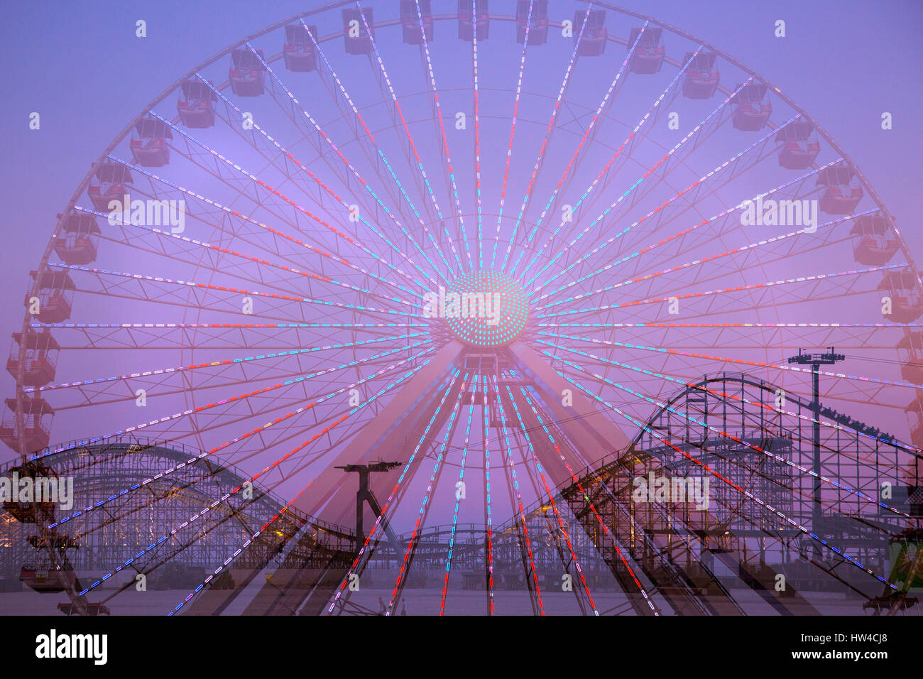 Double exposure of ferris wheel and roller coaster Stock Photo - Alamy