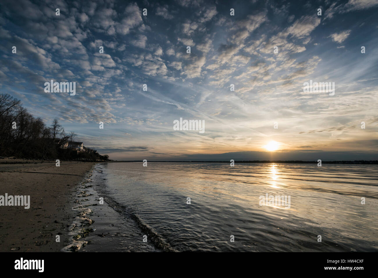 Sunset on ocean beach Stock Photo - Alamy