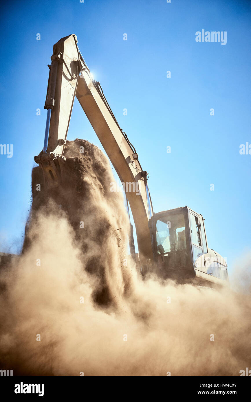 Dust from digger digging dirt Stock Photo - Alamy
