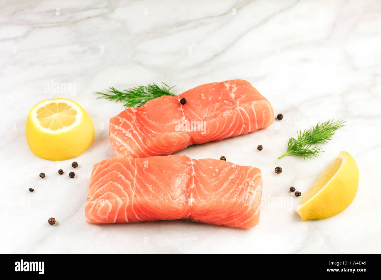 Two slices of salmon on white marble with copyspace Stock Photo - Alamy