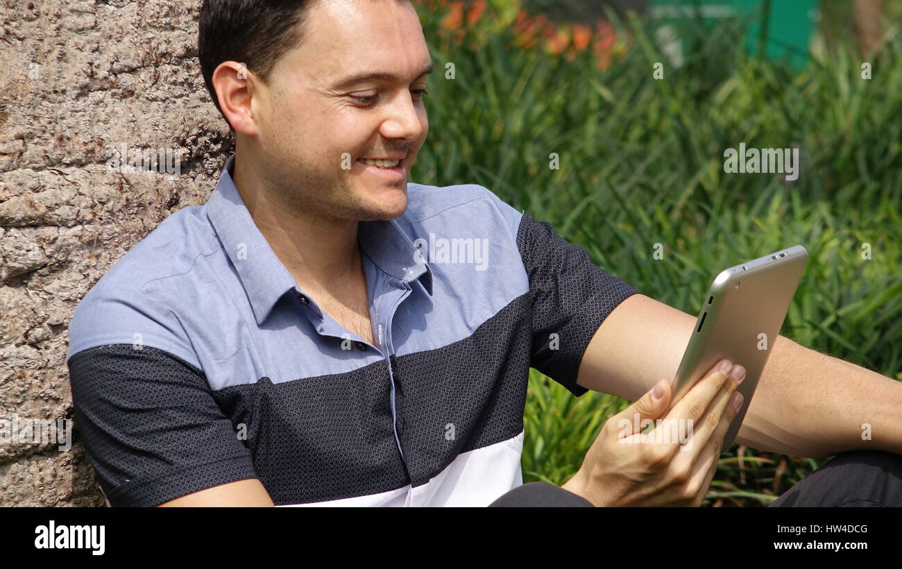 Happy Man Using Tablet Stock Photo - Alamy