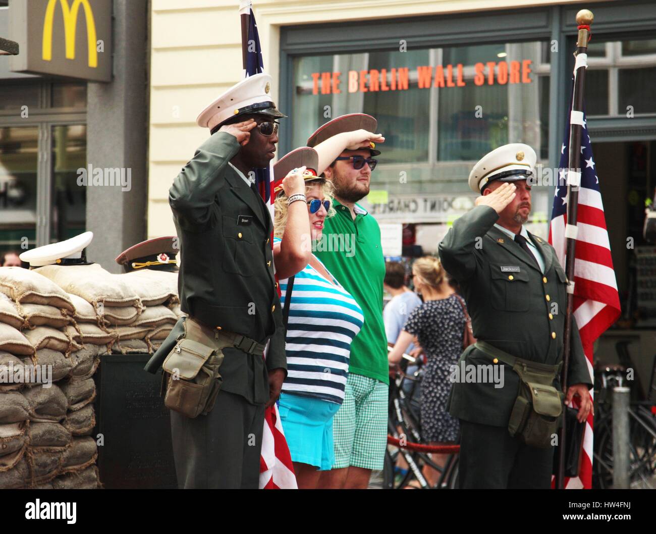 Tourists (C) posing for photos together with men dressed up as military ...