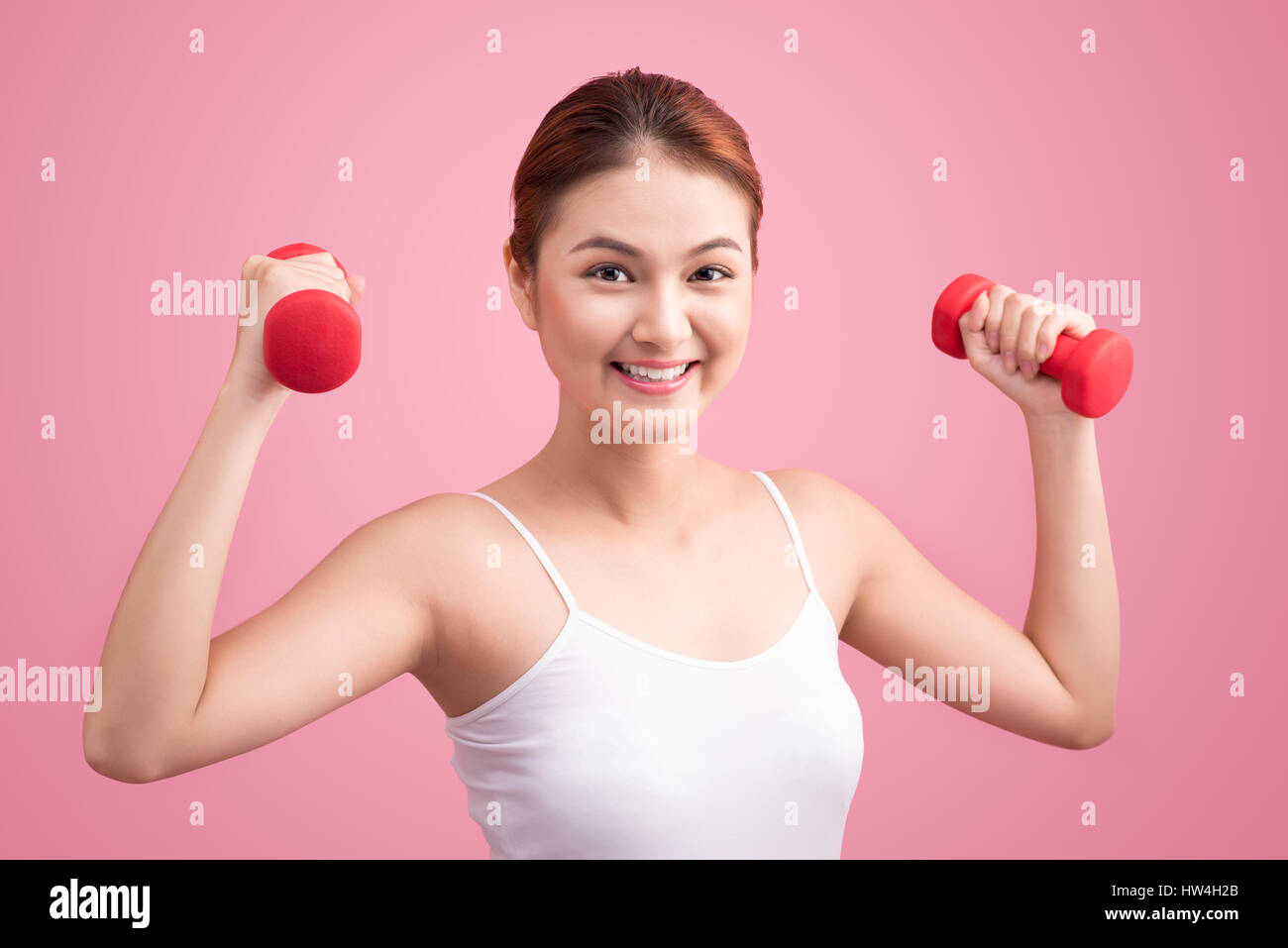 Woman Lifting Weights. Fitness woman lifting weights smiling happy on ...