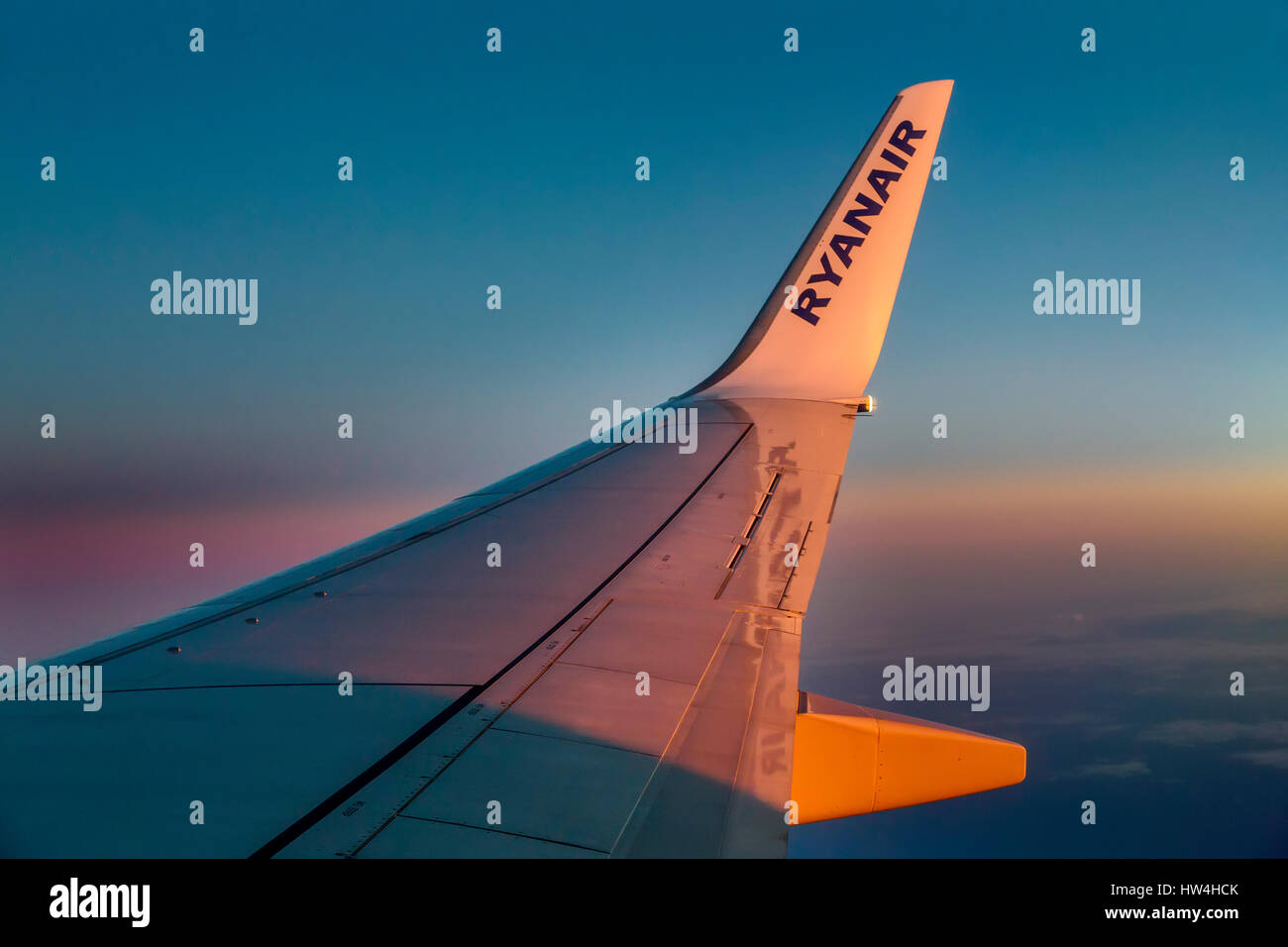 View of airplane wing through window Stock Photo - Alamy