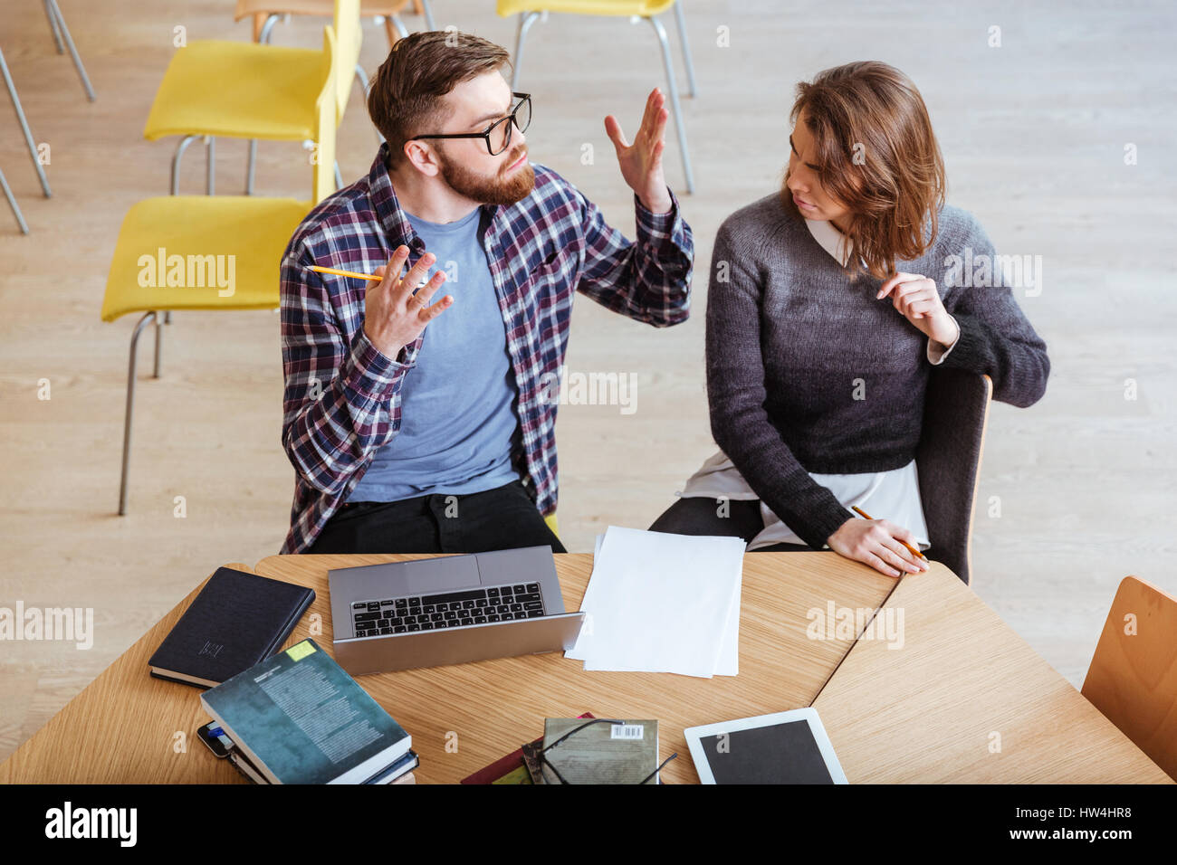 Picture of angry students sitting in library while writing notes and ...