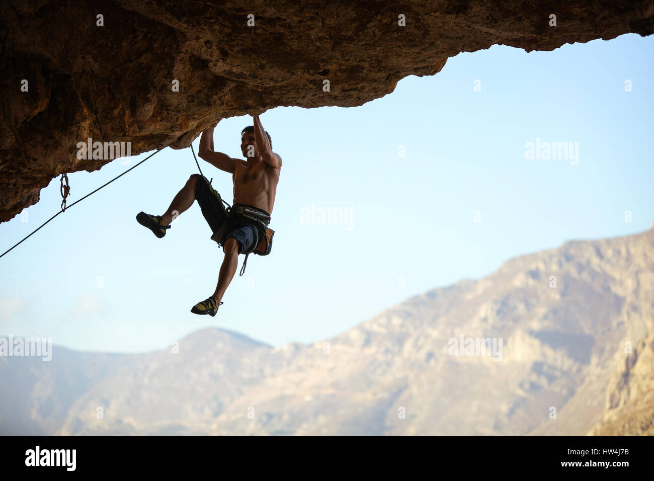 Man hanging on cliff hi-res stock photography and images - Alamy