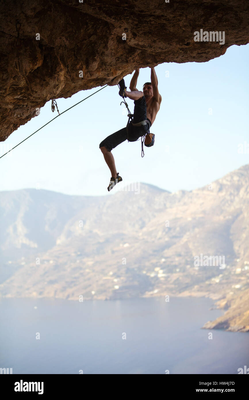 Man hanging on cliff hi-res stock photography and images - Alamy