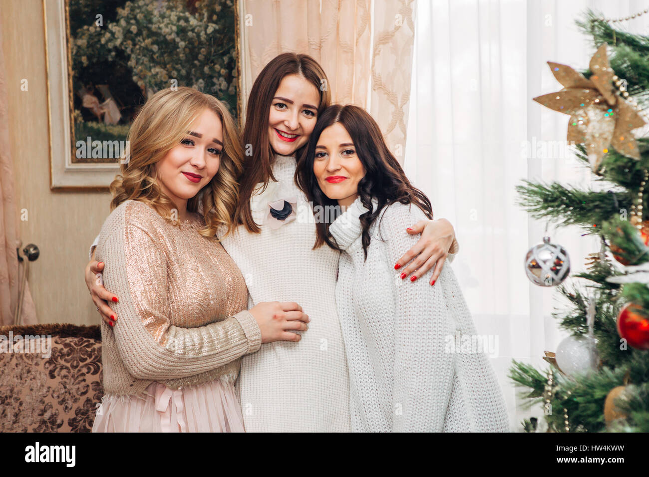 three beautiful sisters posing for the camera and smiling Stock Photo ...