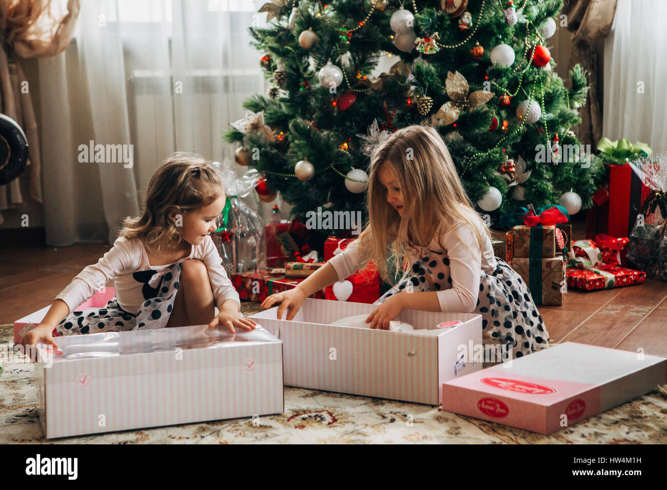 Twin little girls with presents Stock Photo - Alamy
