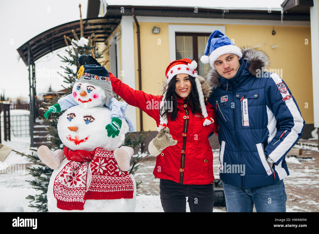 happy couple with snowman Stock Photo - Alamy