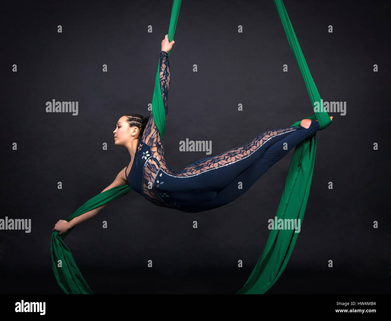 woman's aerial acrobatics in the paintings - dark background. Studio ...