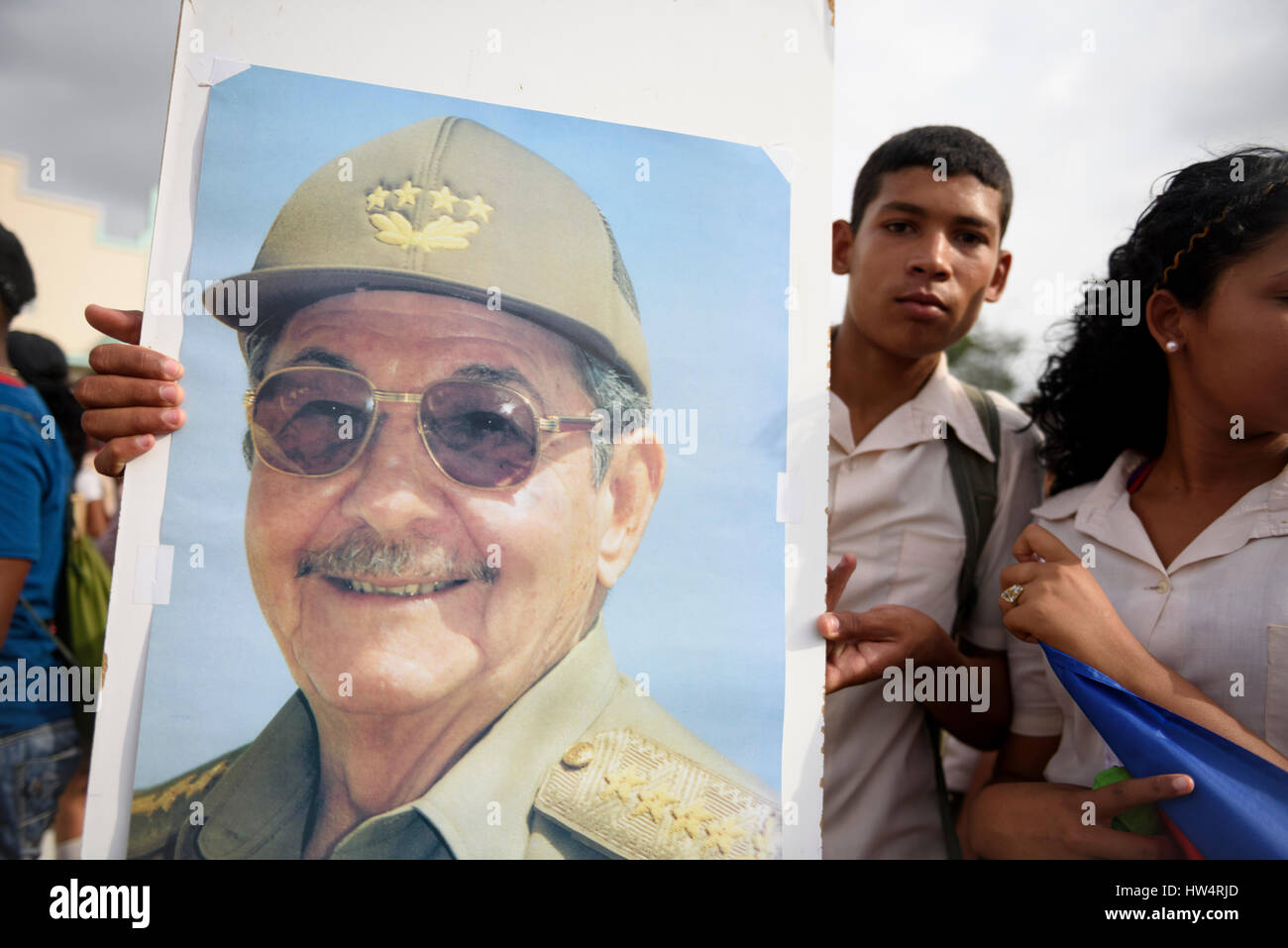 School children carrying a photograph of Raul Castro during the May Day ...