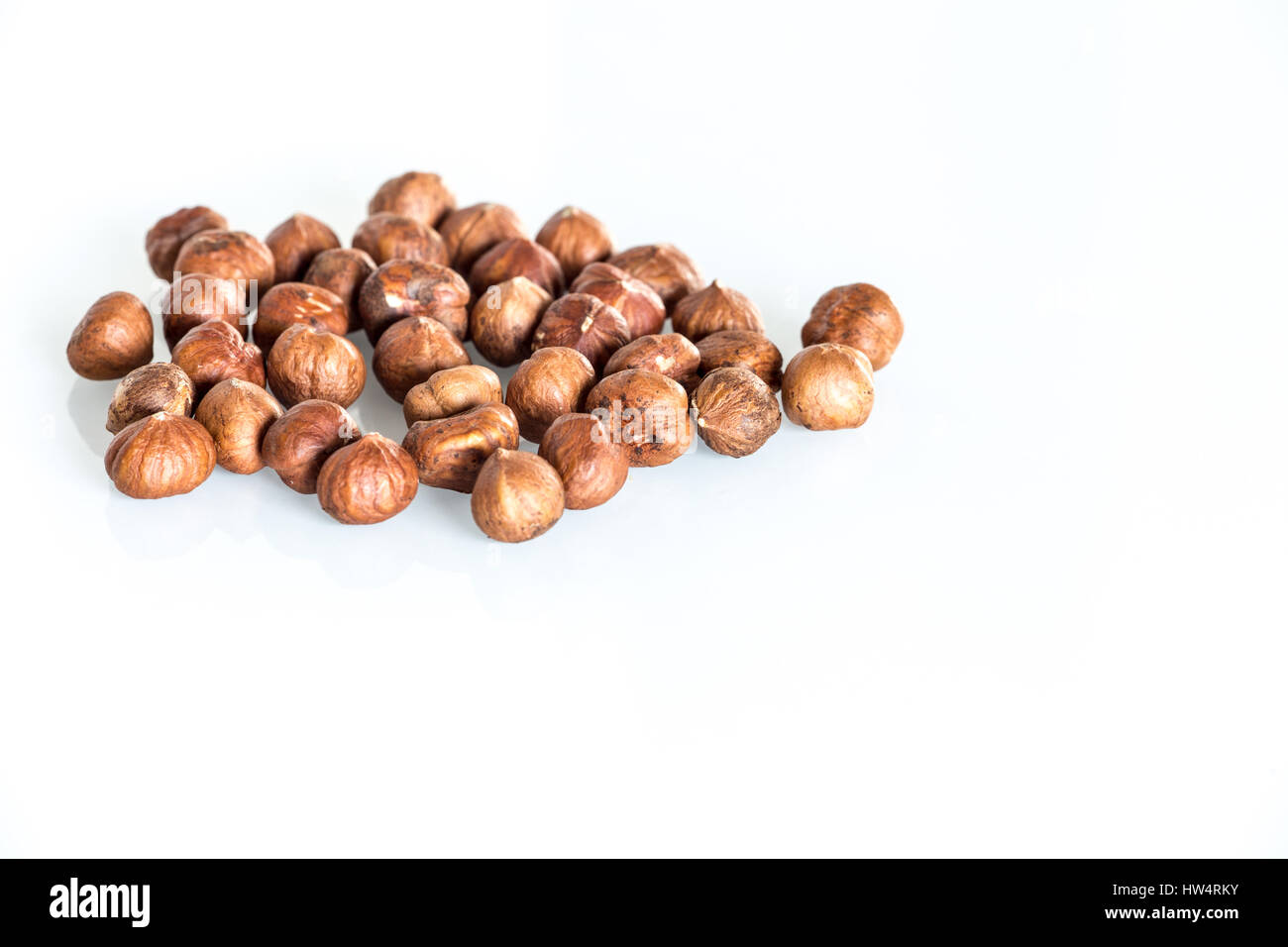 Delicacies hazelnuts scattered on the white background Stock Photo - Alamy