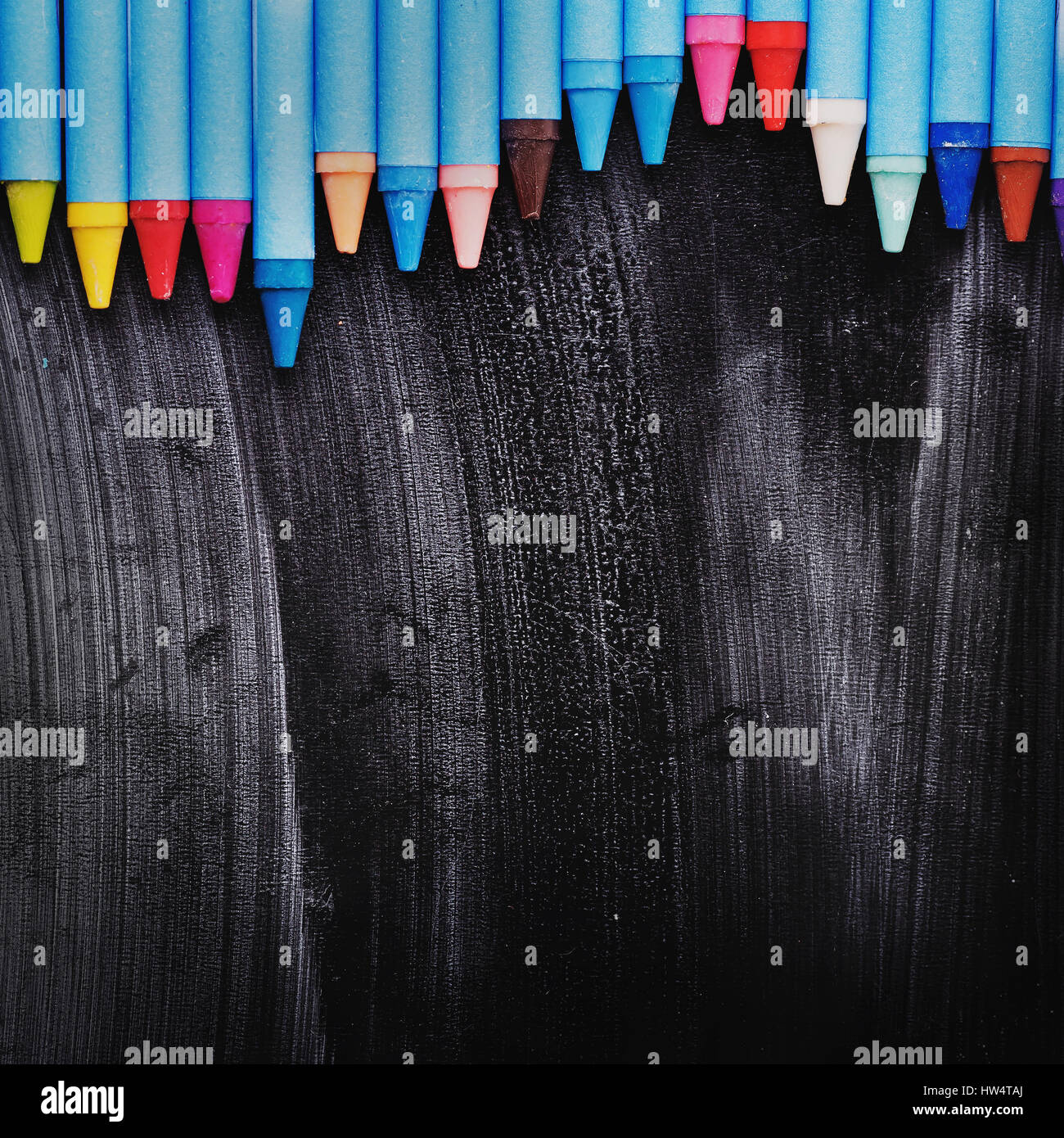 colorful crayons on the board for drawing Stock Photo - Alamy