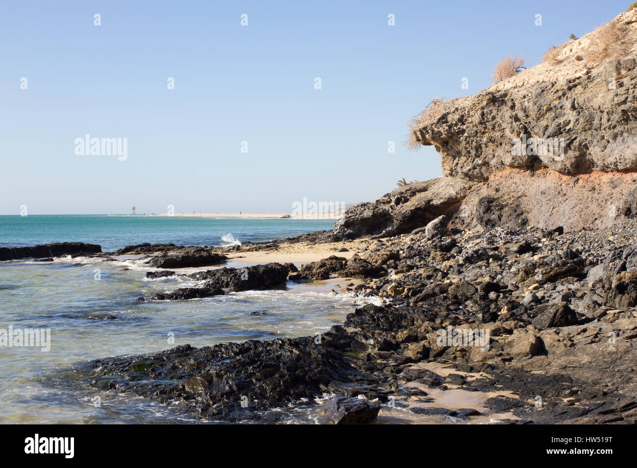 Black rocks of Costa Calma beach. Blue sea line. Playa Barca ...