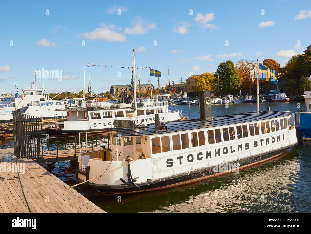 Boats flying Swedish flag moored on waterfront, Stockholm, Sweden ...