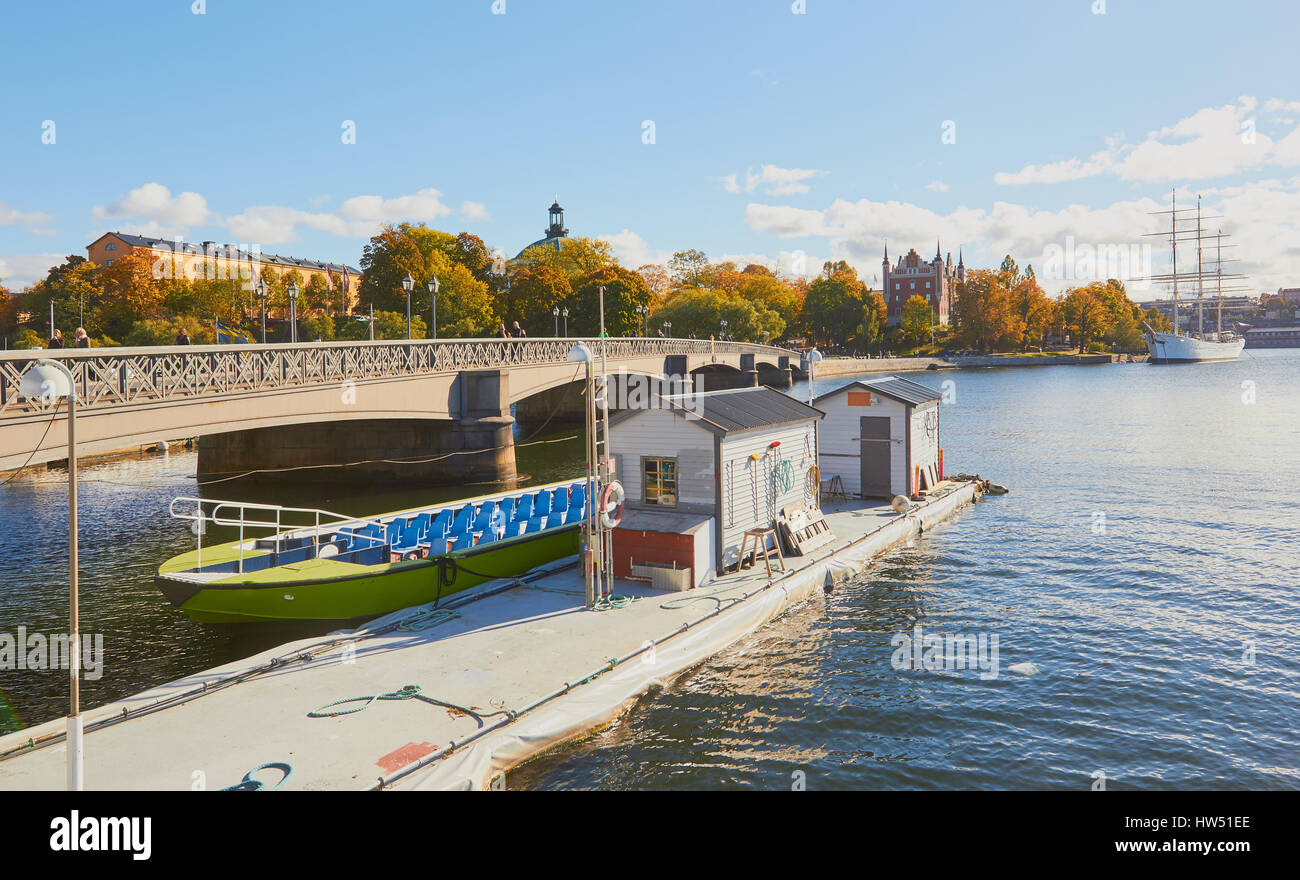 Stockholm autumn scene with Skeppsholmsbron bridge and open top ...