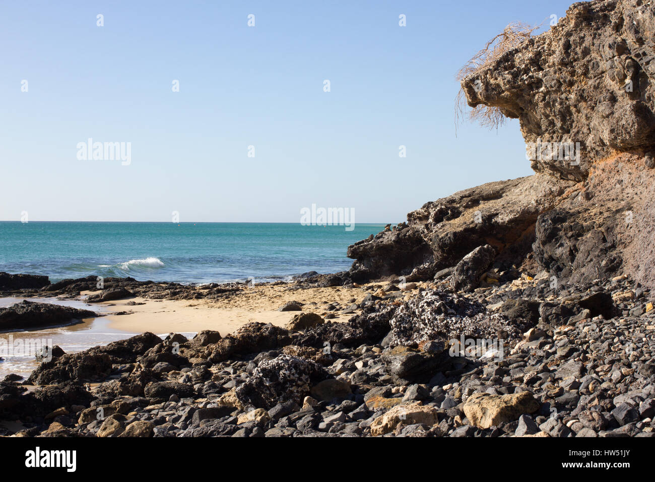 Black rocks of Costa Calma beach. Blue sea line. Playa Barca ...