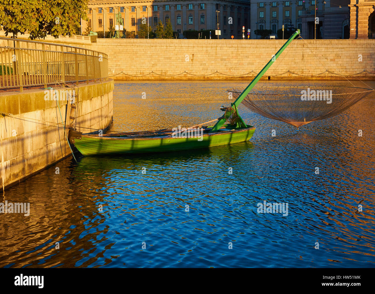 Boat with giant fishing net at sunrise, Helgeandsholmen, Stockholm ...